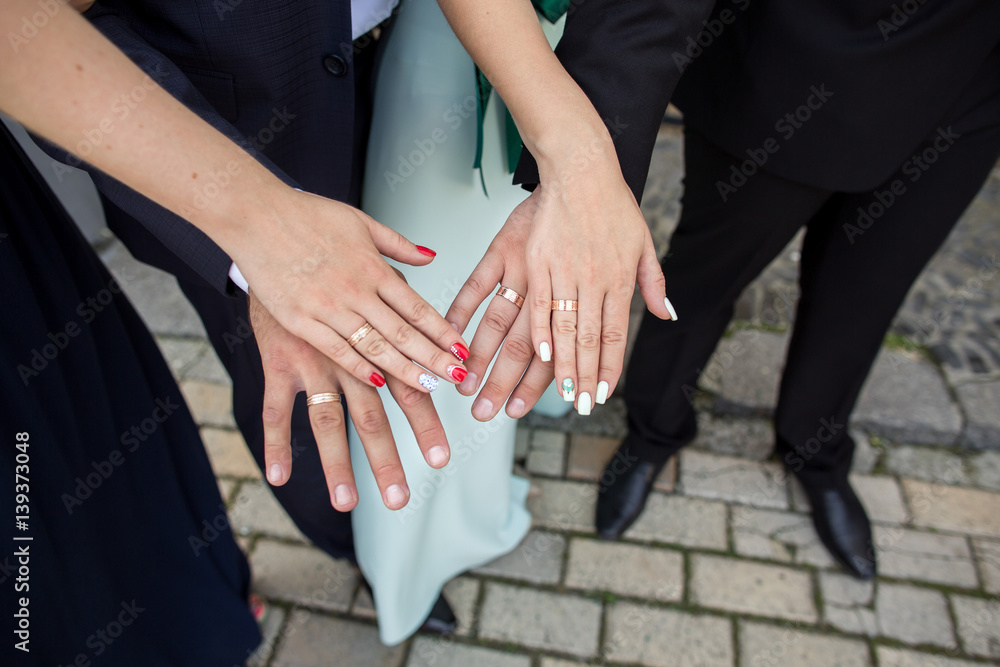 Two women and two men hands with wedding rings. Proposal of marriage ...