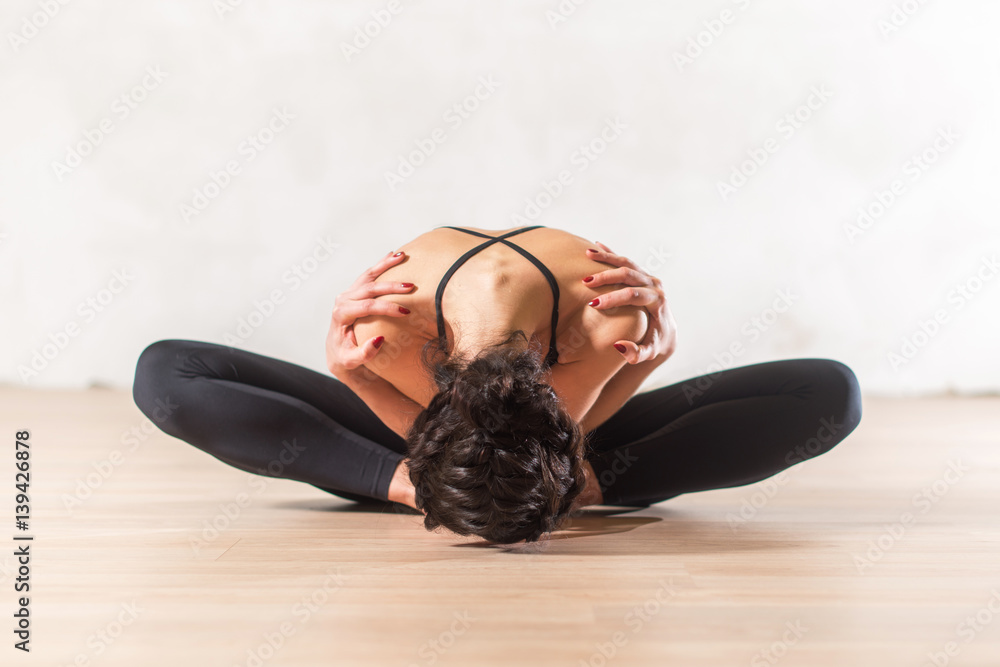 Dancer doing advanced butterfly stretch exercise sitting leaning ...