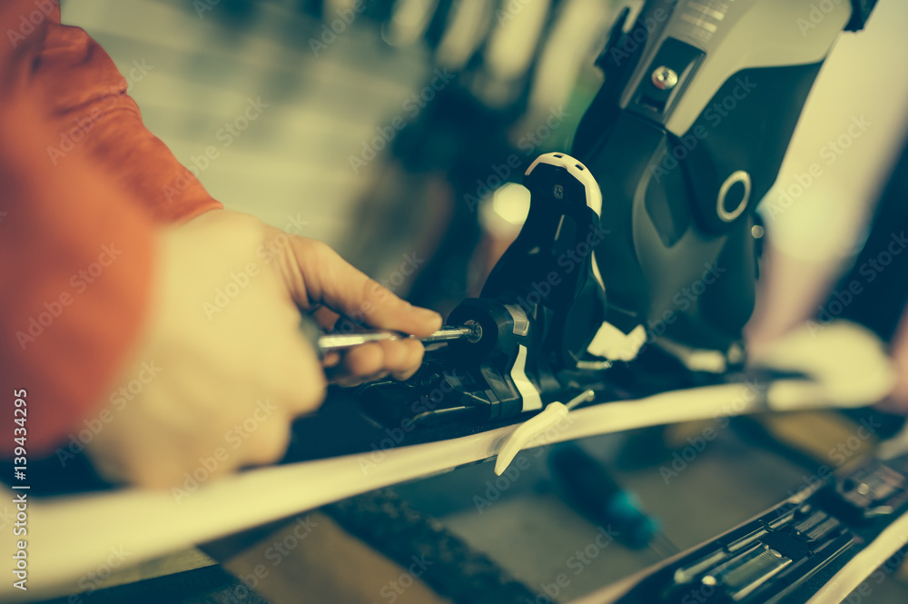 Ski repair shop worker adjust the bindings Stock Photo | Adobe Stock