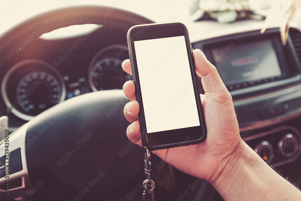 hand holding phone with white screen in car Stock Photo | Adobe Stock
