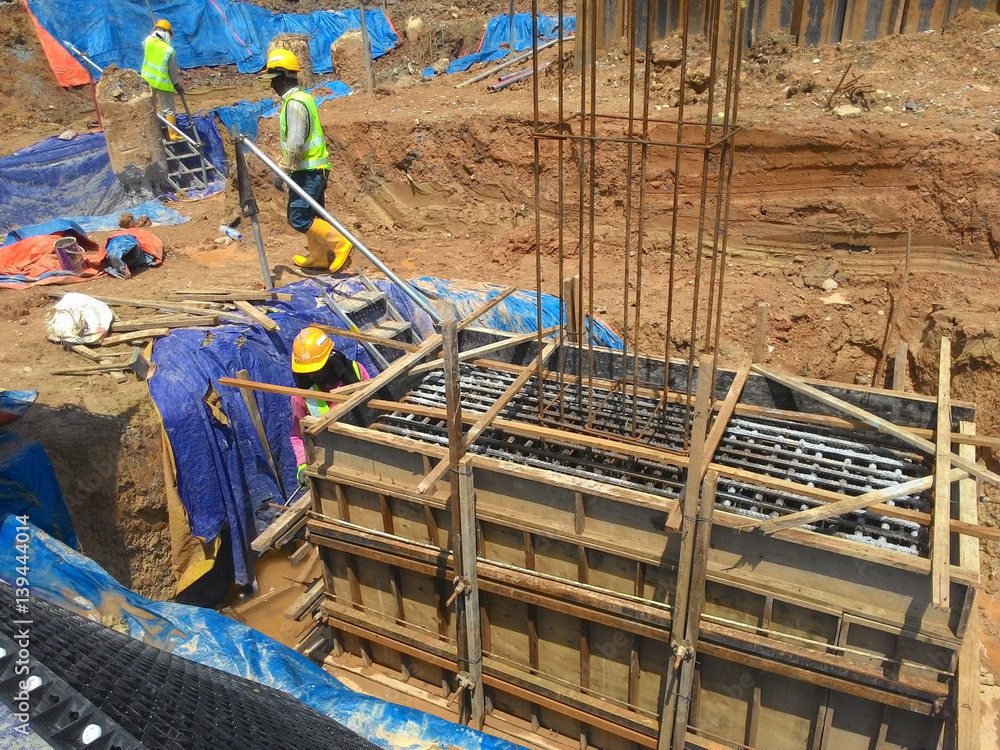 Construction workers fabricating pile cap steel reinforcement bar and ...