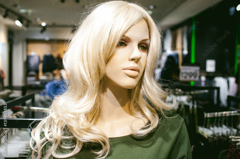 dummy on a shop window. With a female human face blonde hair wig Stock ...