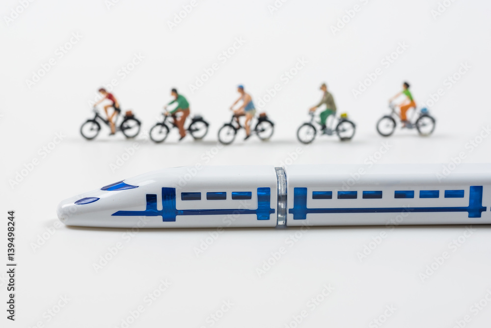 high speed train model and miniature people riding a bike Stock Photo ...