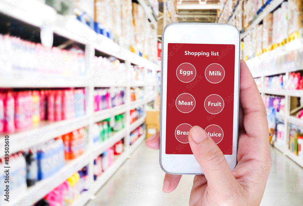 Hand holding smart phone with grocery shopping check list application ...