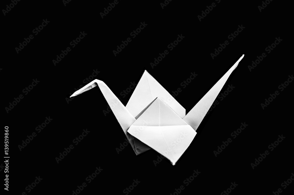 Origami crane isolated on black background Stock Photo | Adobe Stock