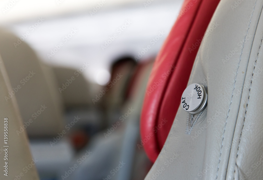 empty clothes hanger on seat in a flying aircraft Stock Photo | Adobe Stock