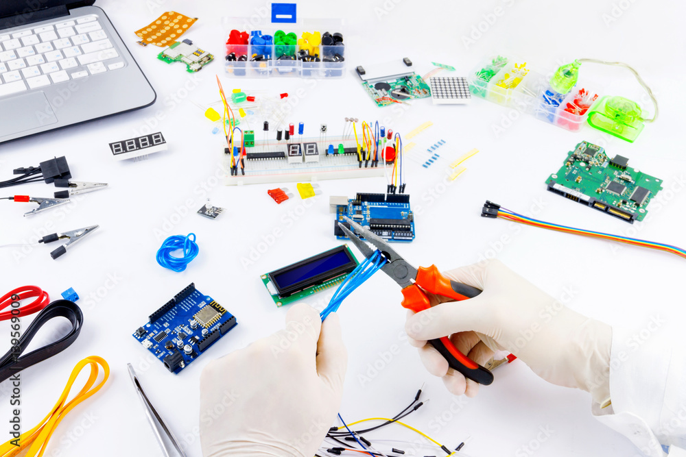 Foto de Engineer is working wiith pliers and wires. Microcontrollers ...