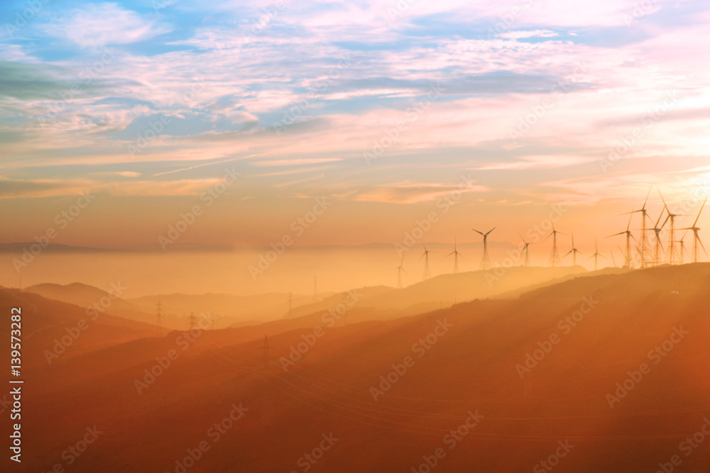 Wind turbines during sunset with Andalusian hills, Atlantic ocean and ...