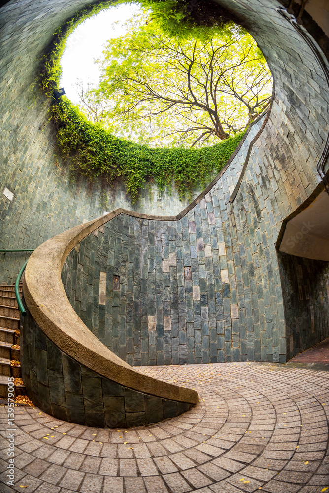 Spiral staircase of underground crossing in tunnel at Fort Canning Park ...