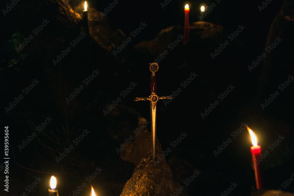 Similar to Excálibur picture - sword in tree and candles around at ...