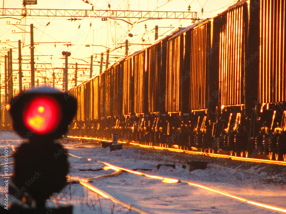 Railway traffic light shows blue signal on railway with blur effect and ...