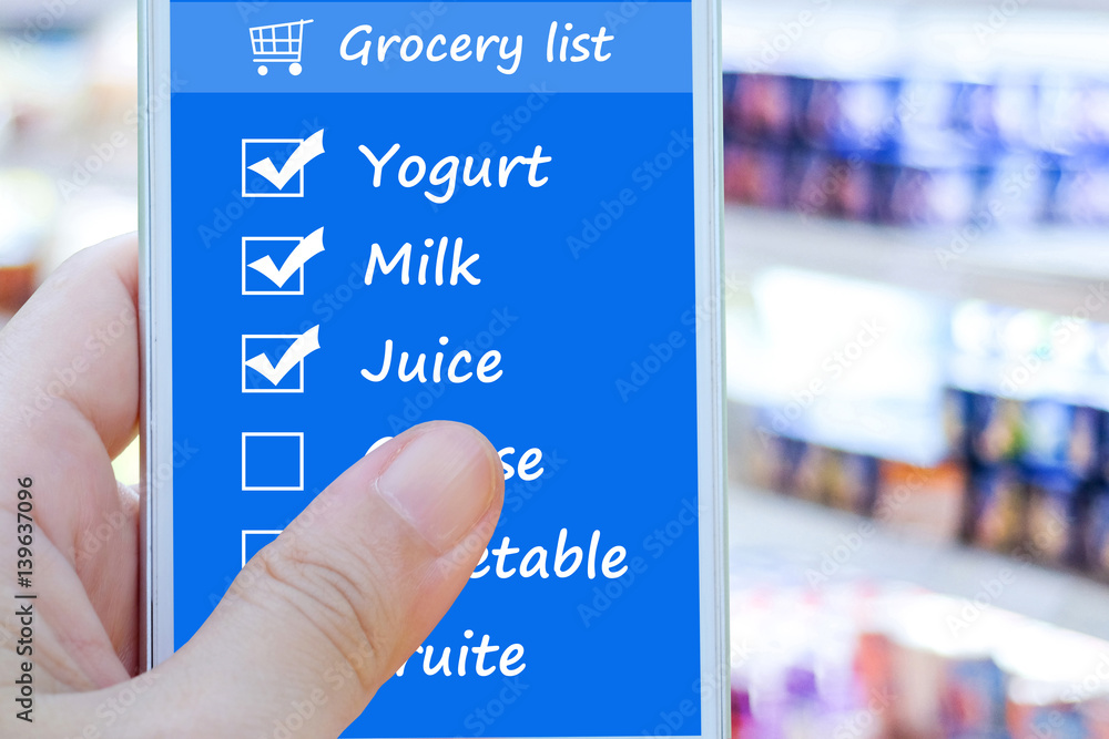 Hand holding smart phone with grocery shopping check list application ...