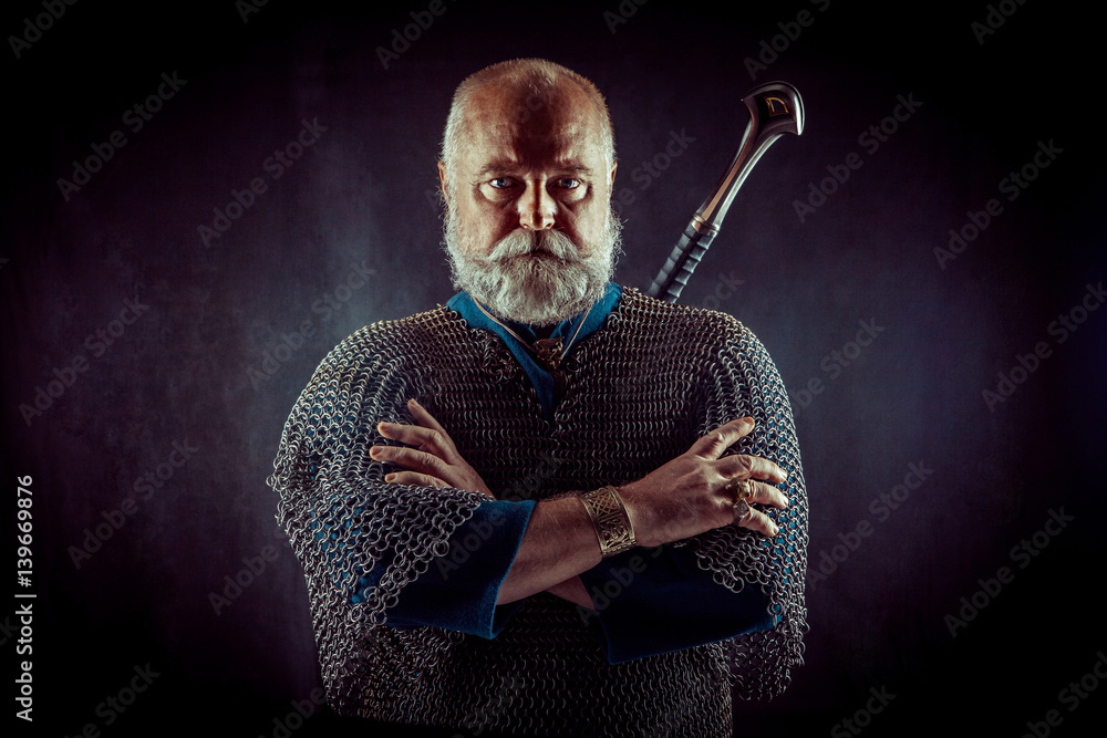 Powerful bearded knight with the sword on the dark background Stock ...