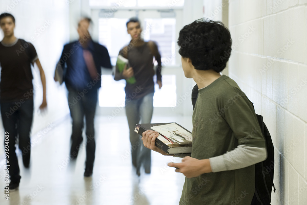 Teenage boy running from bullies Stock Photo | Adobe Stock