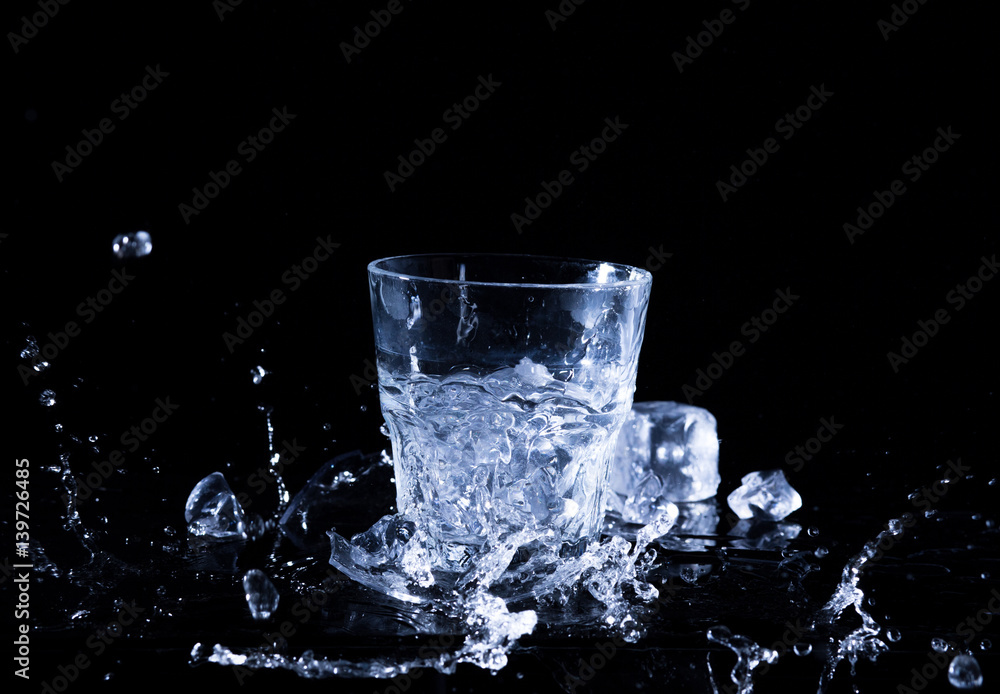Water splash in a glass. A glass of cold water. Cold water with ice ...