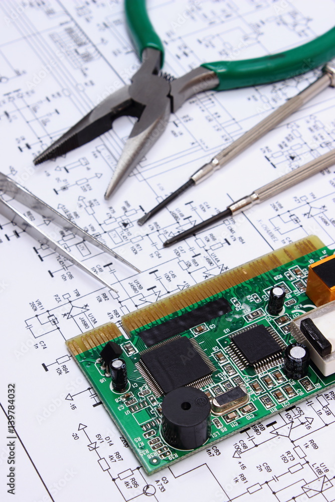 Printed circuit board and precision tools on diagram of electronics ...