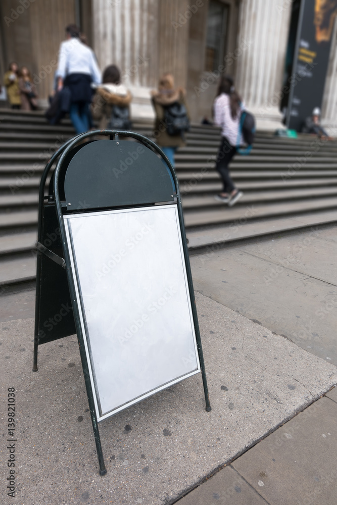 blank empty white sign board on concrete floor in front of entrance way ...