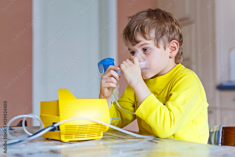 Cute kid boy making inhalation therapy by the mask of inhaler Stock ...