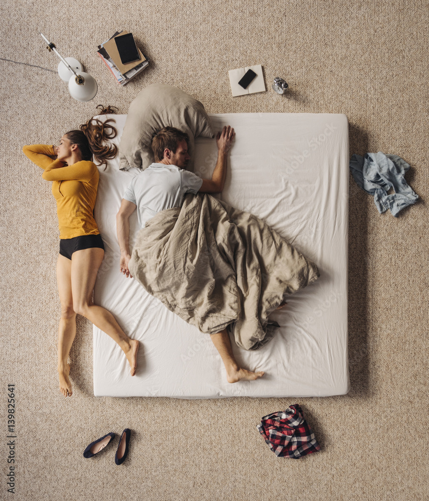 Man lying in bed with woman lying besides, top view Stock Photo | Adobe ...