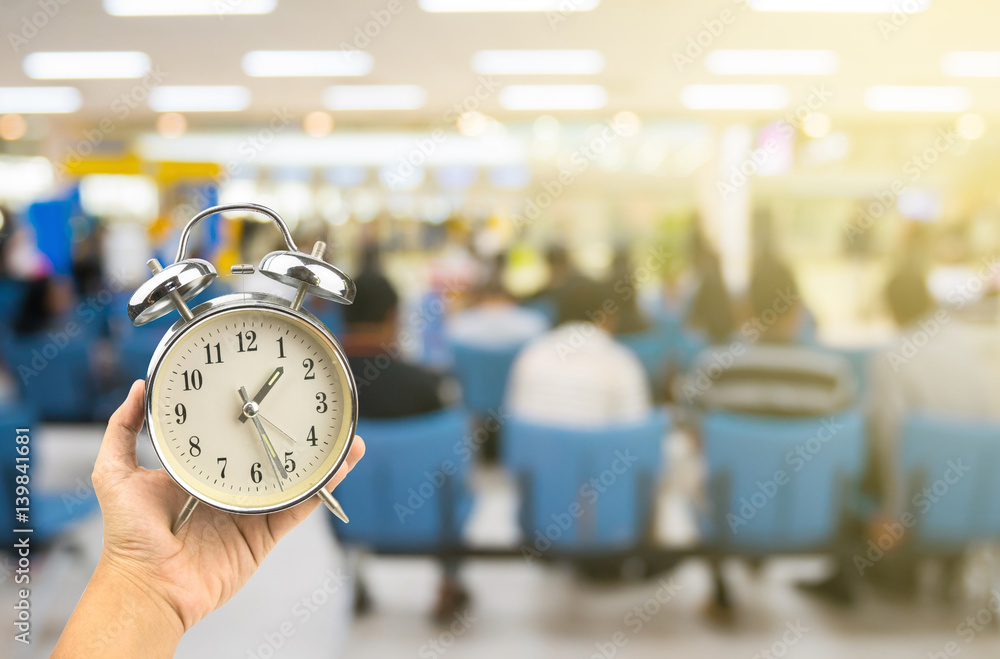 hand with clock in health concept blur hospital background Stock Photo ...