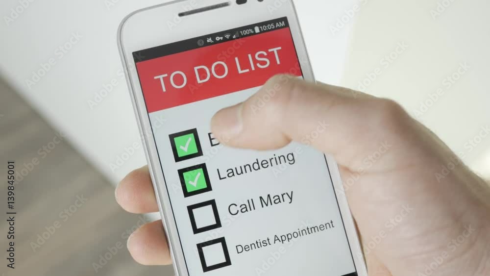 Using a To Do list app on a smartphone. Checking the tasks one by one ...