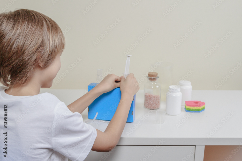 Young boy making science experiments. Education concept. Stock Photo ...