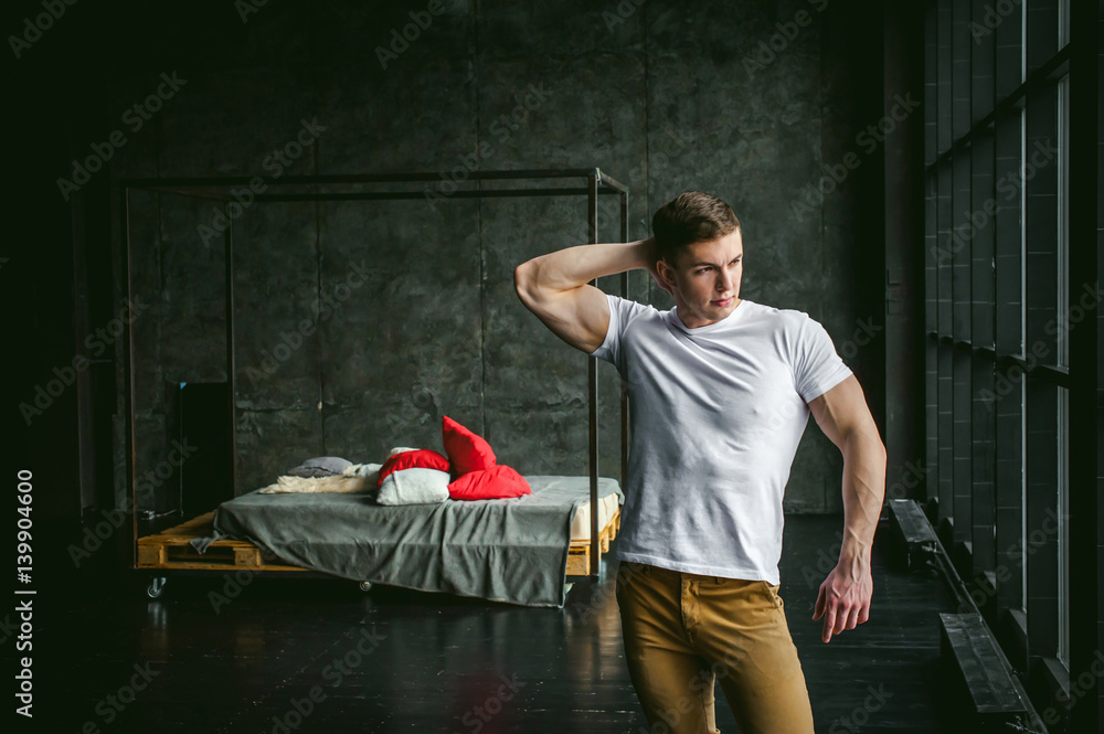Young sexy men bodybuilder athlete, studio portrait in loft on the ...