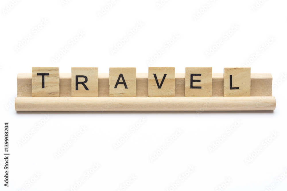 Word ''travel'' on scrabble wooden letters on a rack, isolated on white ...