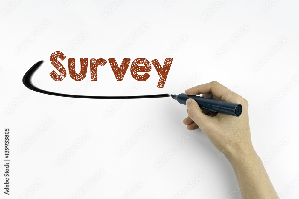 Hand with marker writing - Survey concept. White paper background ...
