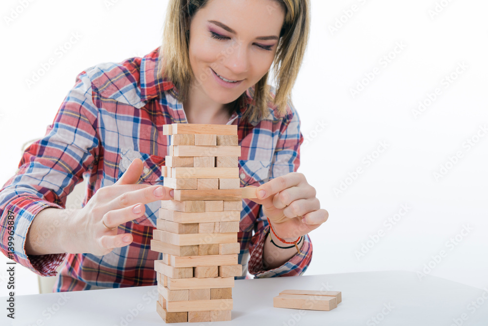 Girl playing Jenga. Full concentration. Entertainment activity. Keep ...