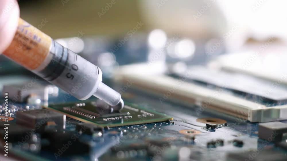 repairing laptop. pouring thermal paste to the laptop processor. close ...