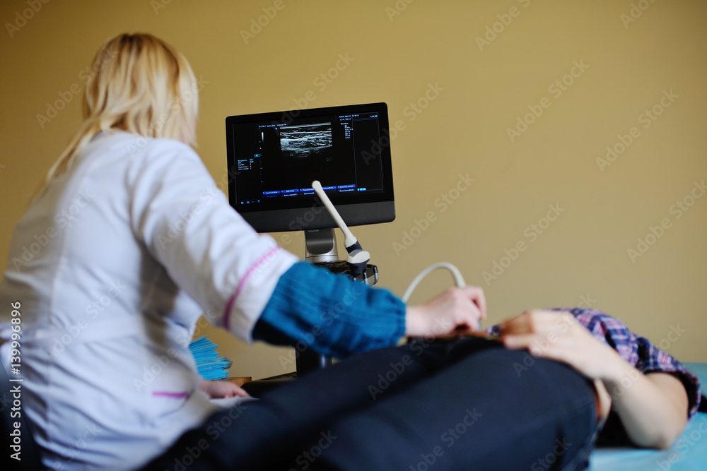 Doctor makes the patient women abdominal ultrasound. Pregnancy ...