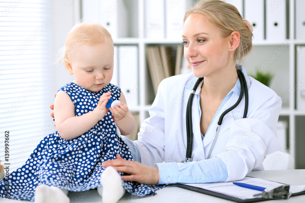 Pediatrician is taking care of baby in hospital. Little girl is being ...
