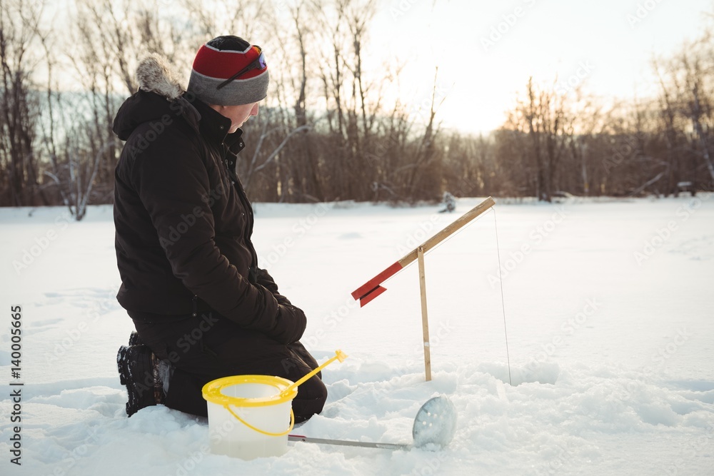 Ice fisherman setting up the bait Stock-Foto | Adobe Stock