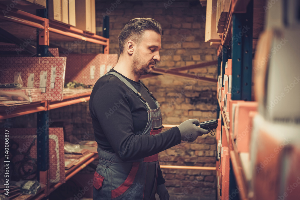 Storekeeper with handheld barcode scanner working in a warehouse Stock ...