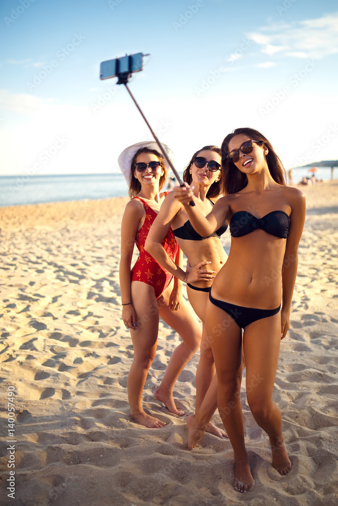 Summer Holidays And Vacation Girls Sunbathing On The Beach Girls