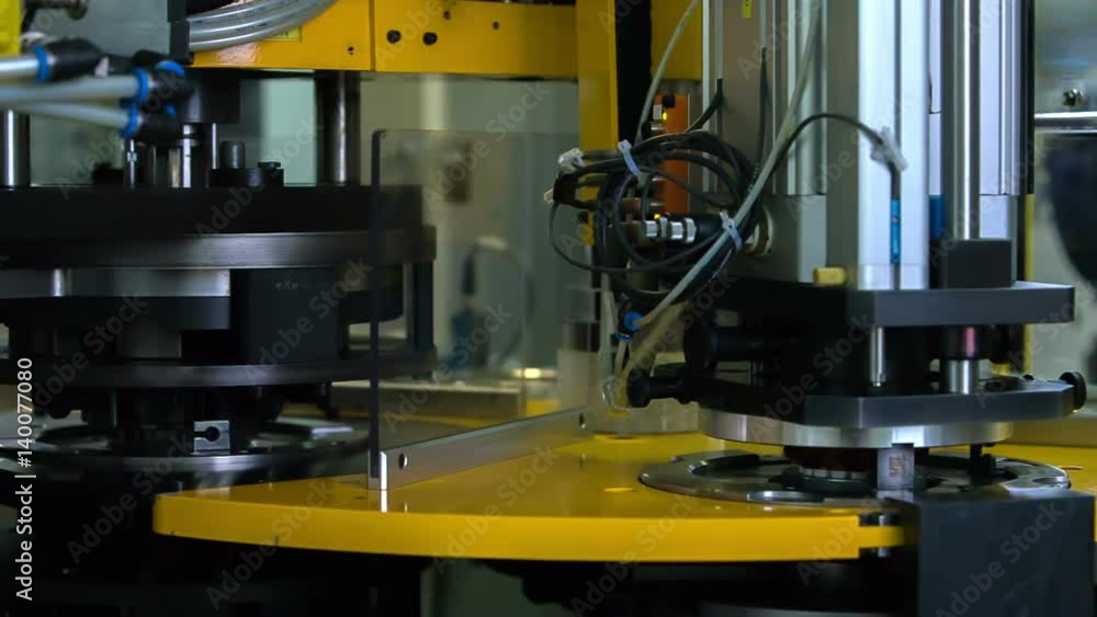 A yellow machine is moving up and down very slowly and it is ...