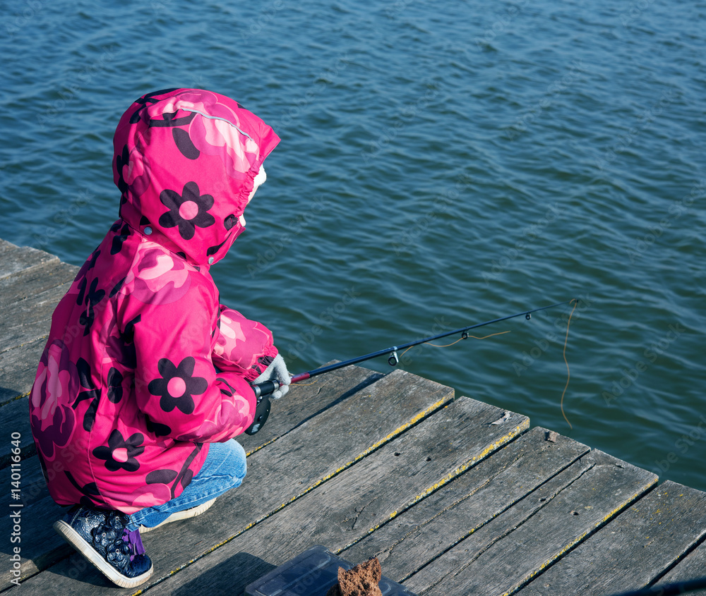 little girl fishing on the pier Stock Photo | Adobe Stock