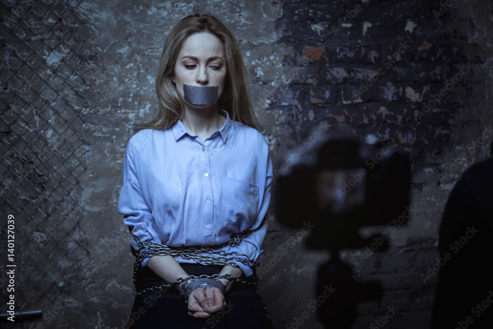Desperate scared woman posing for a ransom Stock Photo | Adobe Stock