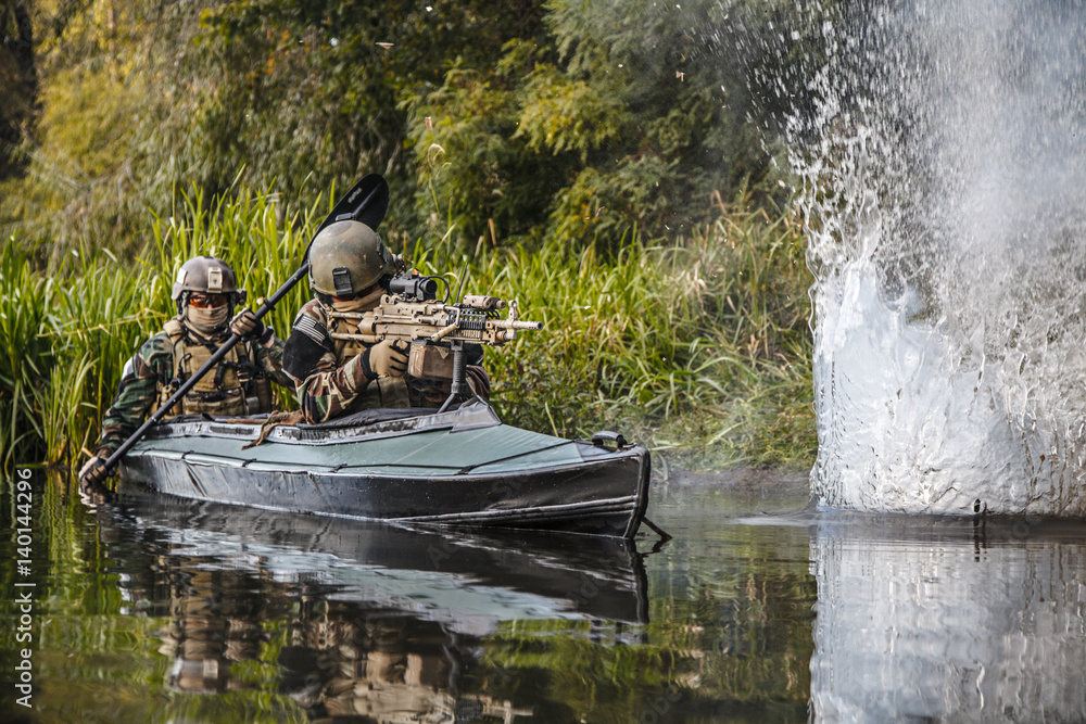 Special forces men with painted faces in camouflage uniforms paddling ...