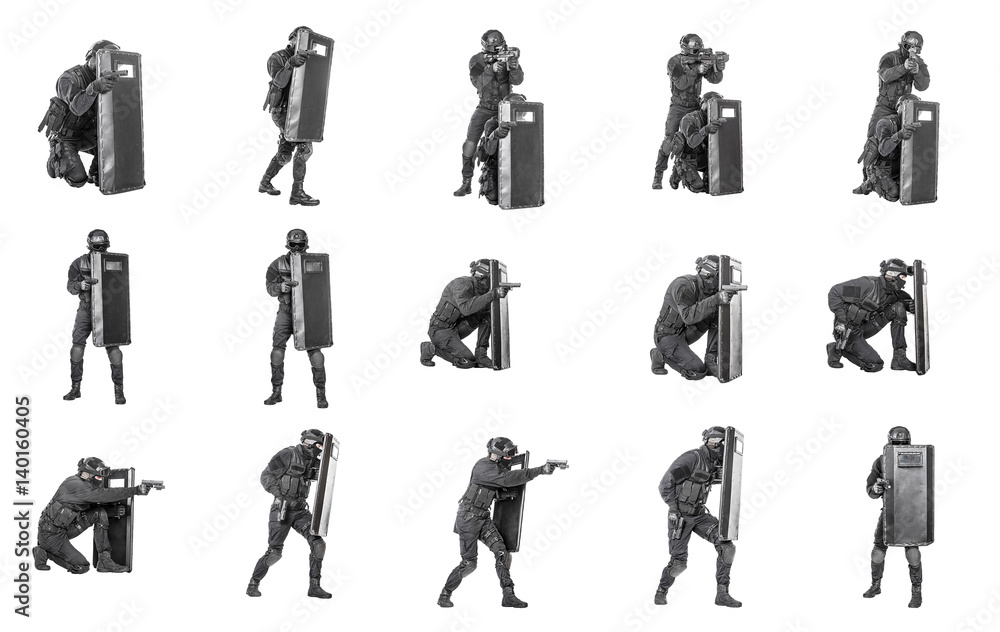 Set of SWAT operators in black uniforms and bulletproof vest with ...