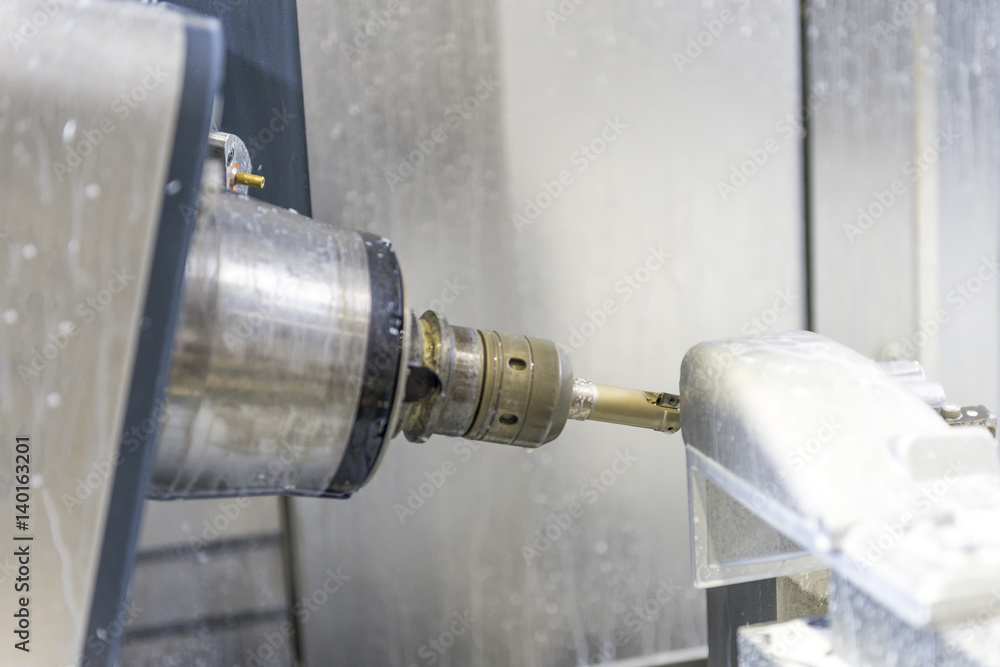 The five-axis Computer Numerical Control (CNC) machine while cutting ... The five-axis Computer Numerical Control (CNC) machine while cutting ...
