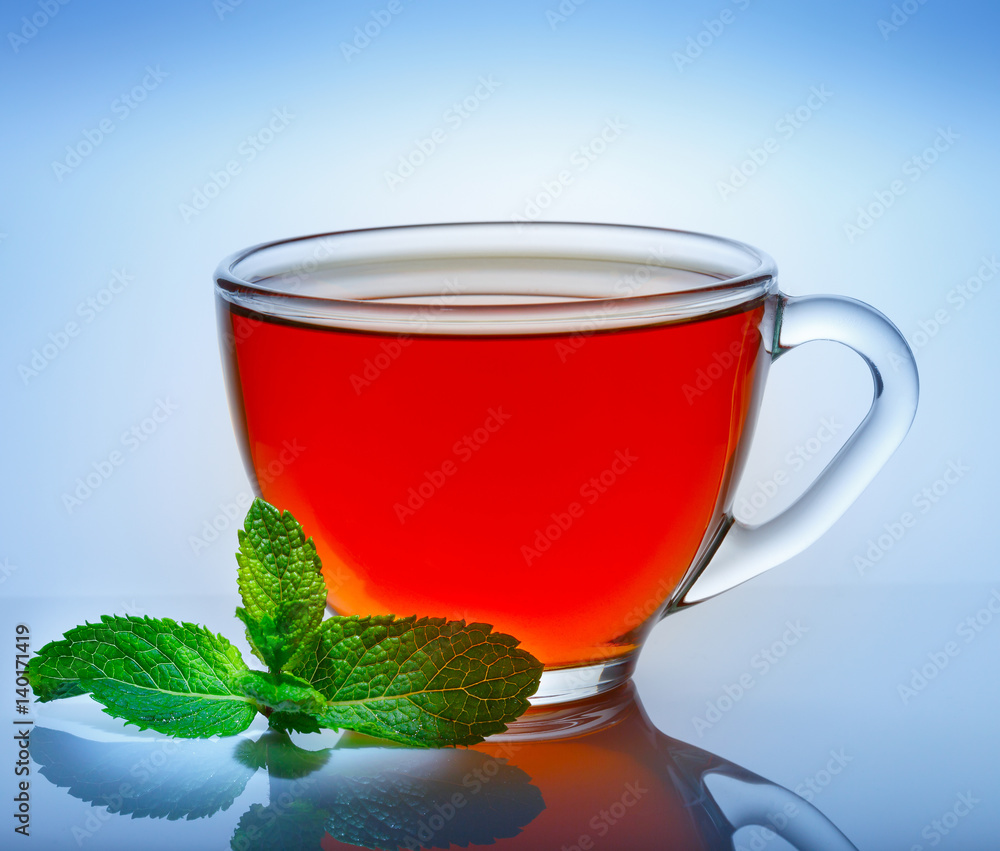 Beautiful cup of tea with reflection on a blue background Stock Photo ...