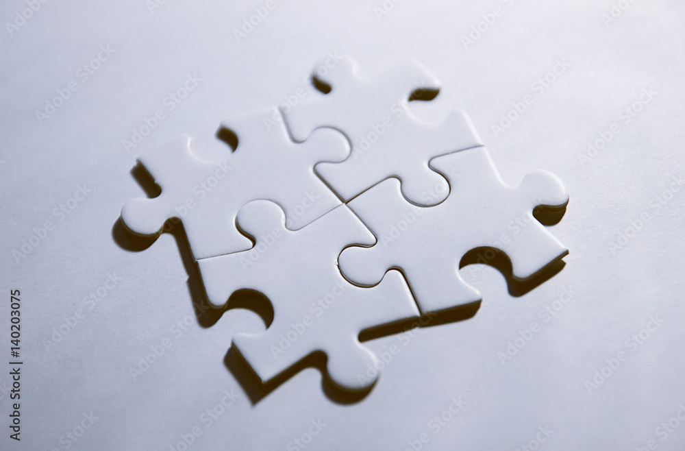 Vier zusammenhängende Puzzleteile auf weißem Grund Stock Photo | Adobe ...