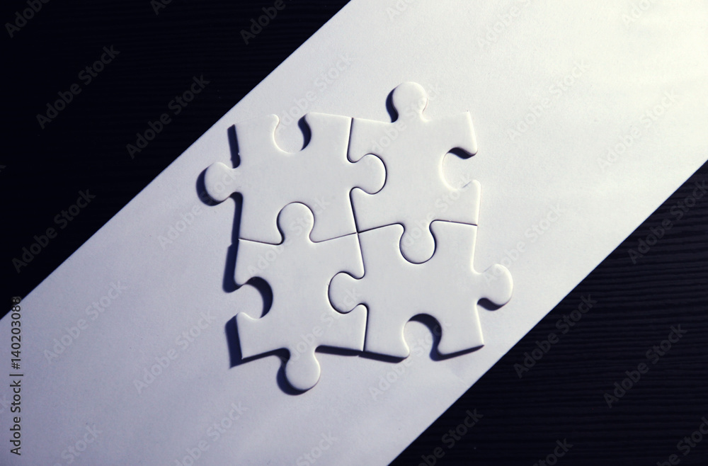 Vier zusammenhängende Puzzleteile auf weiß/schwarzem Grund Stock-Foto ...