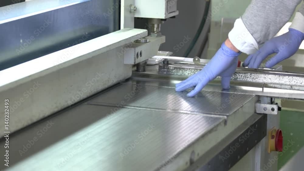 Hydraulic guillotine shear working. Hand of cutting machine operator ...