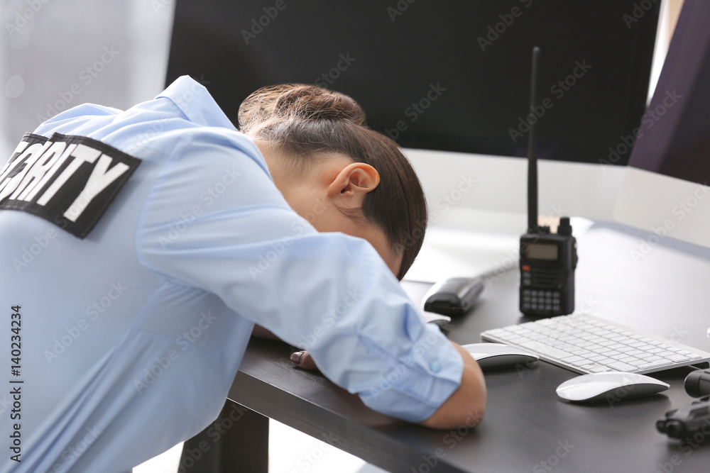 Female security guard sleeping at workplace Stock Photo | Adobe Stock