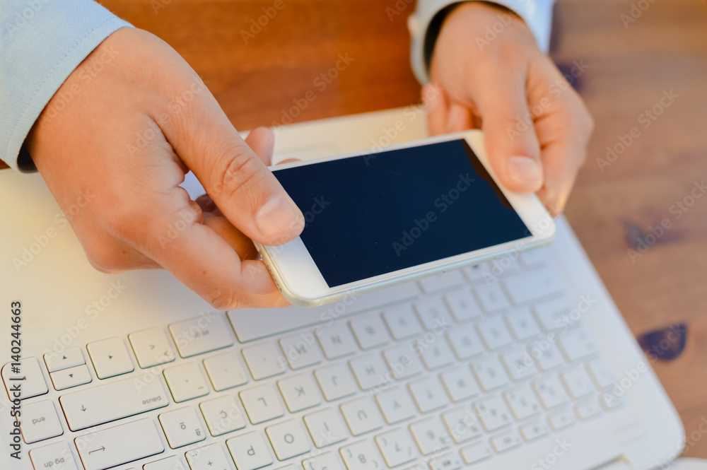 Man hands working using computer and mobile phone. Closeup view of mock ...