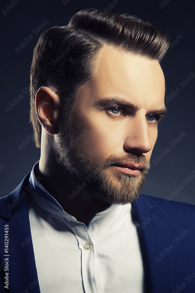 Portrait of handsome stylish caucasian bearded young man in elegant ...