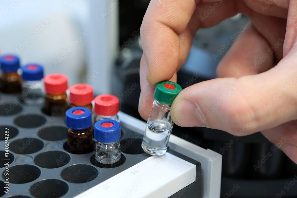 People hand holding a test tube vial sets for analysis in the gas ...
